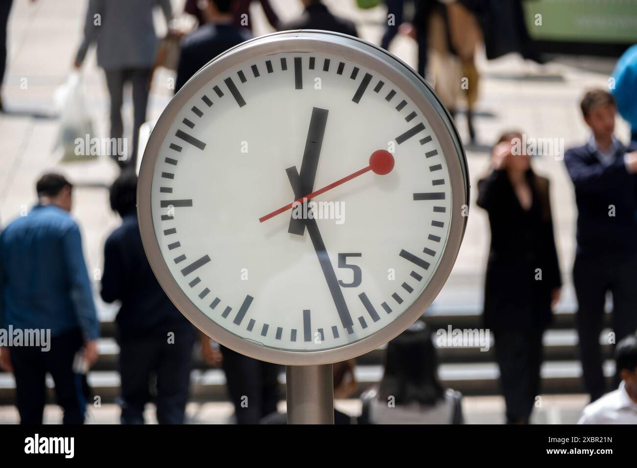 City workers walk under Six Public Clocks, a sculpture by Konstantin ...