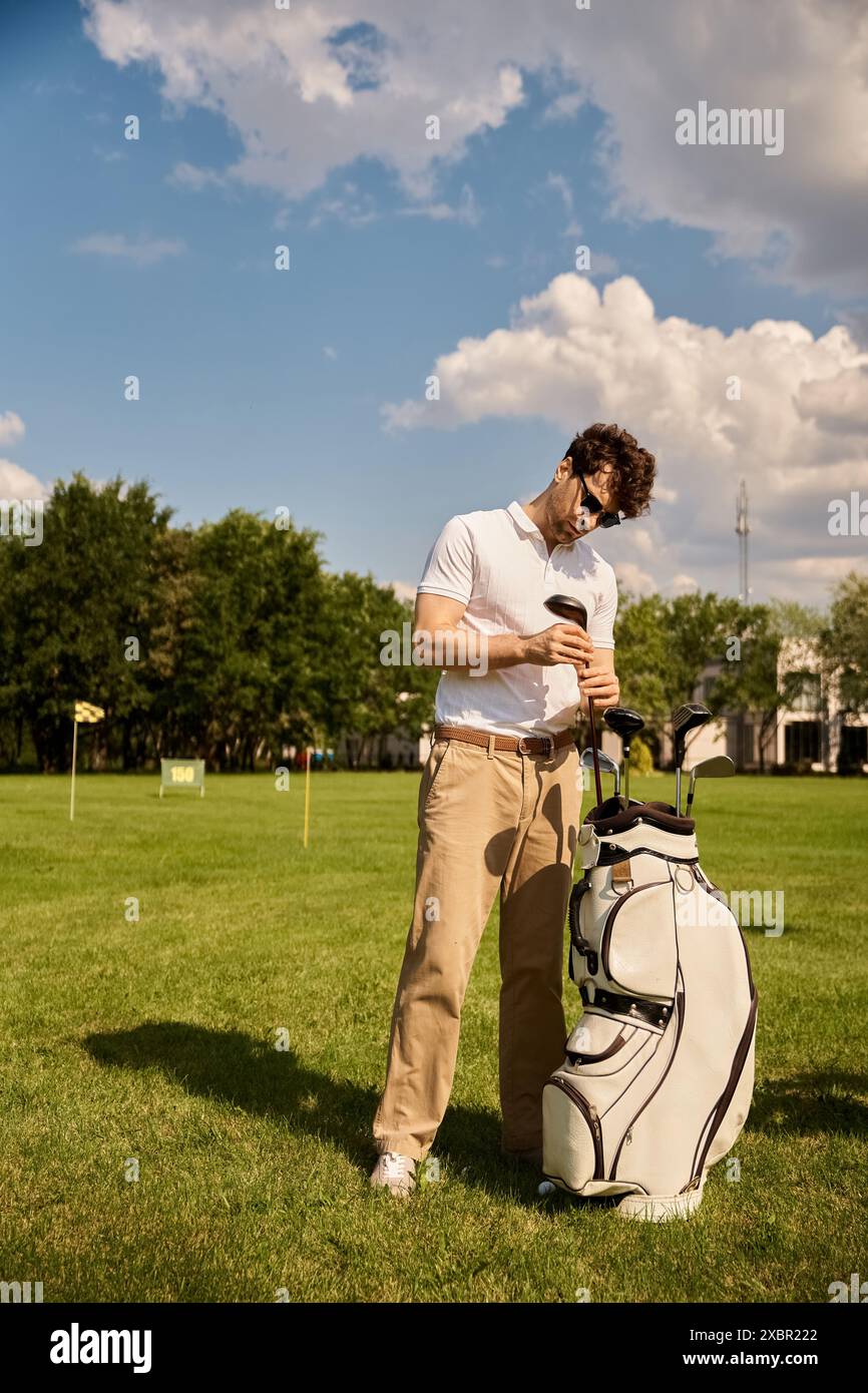 A man in elegant attire stands gracefully beside his golf bag on a lush ...