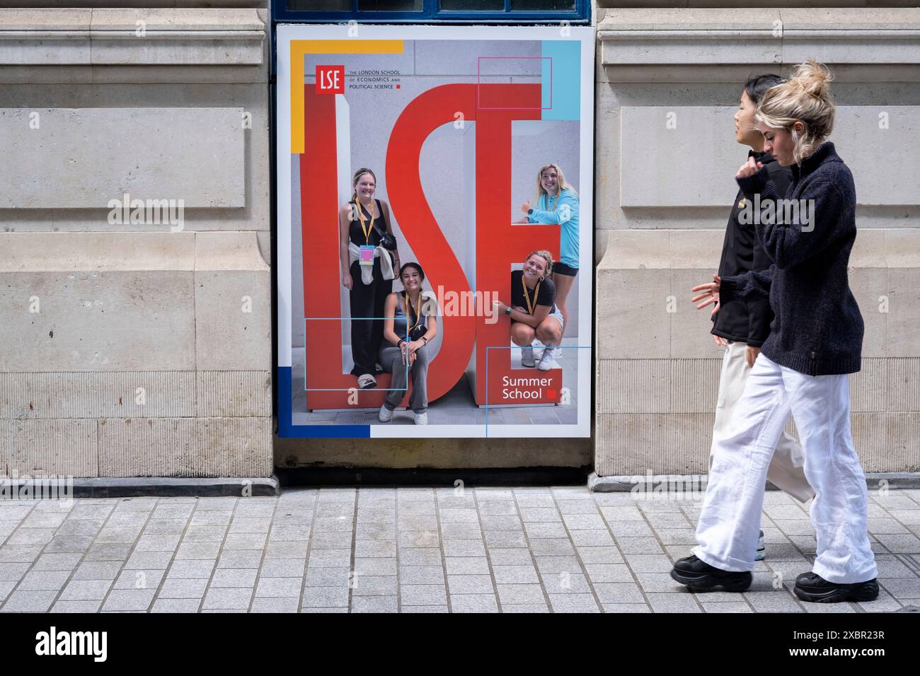 Students around the campus of the LSE London School of Economics passing an LSE Summer School ...
