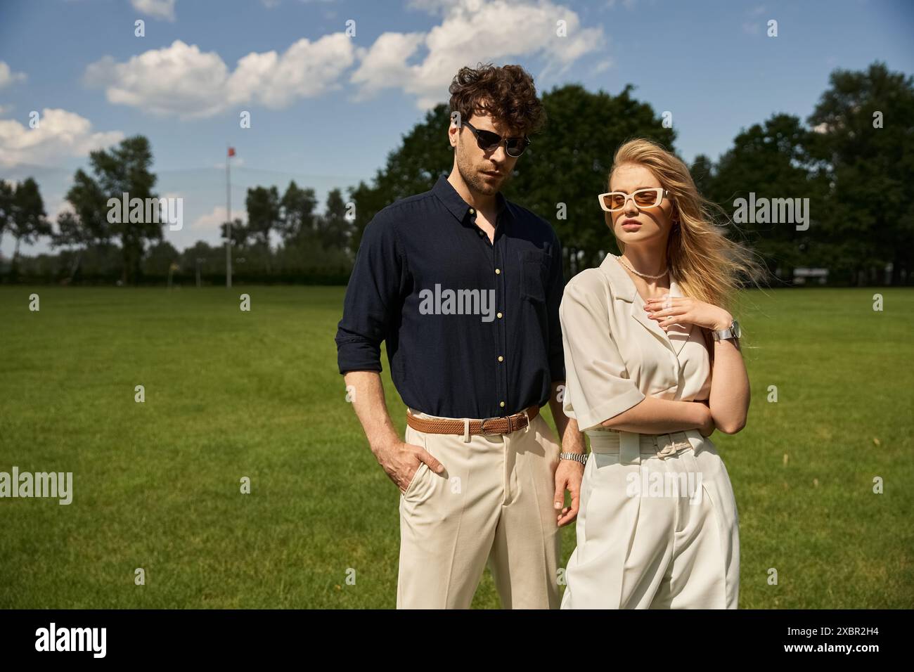 A stylish young couple in upscale attire enjoy a moment together in a ...