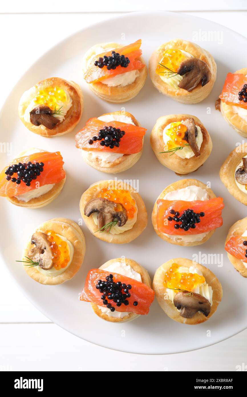 Different delicious puff pastry snacks on white table, top view Stock ...