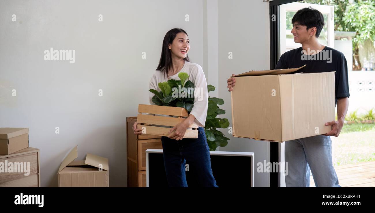 Happy Couple Moving into New House with Boxes and Plants, Starting a ...