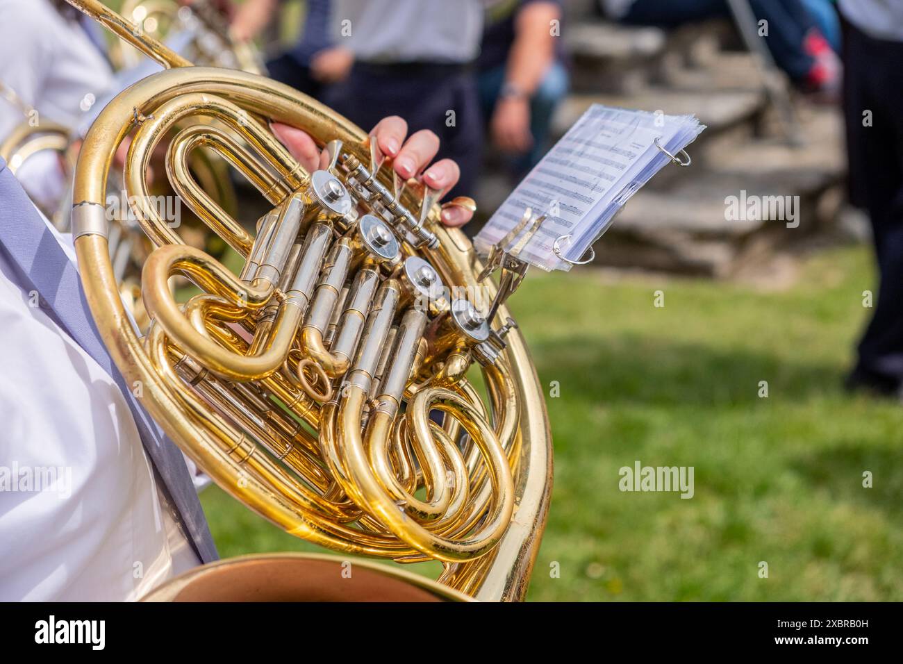 a musician playing the horn in a marching band at an outdoor parade ...
