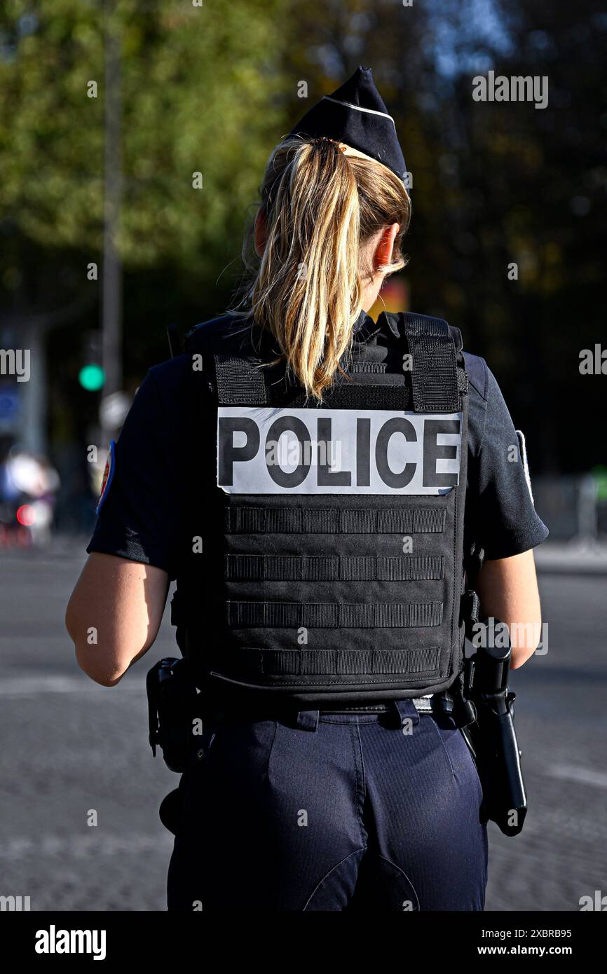 Paris, France. 12th June, 2024. A female police officer (woman) with ...