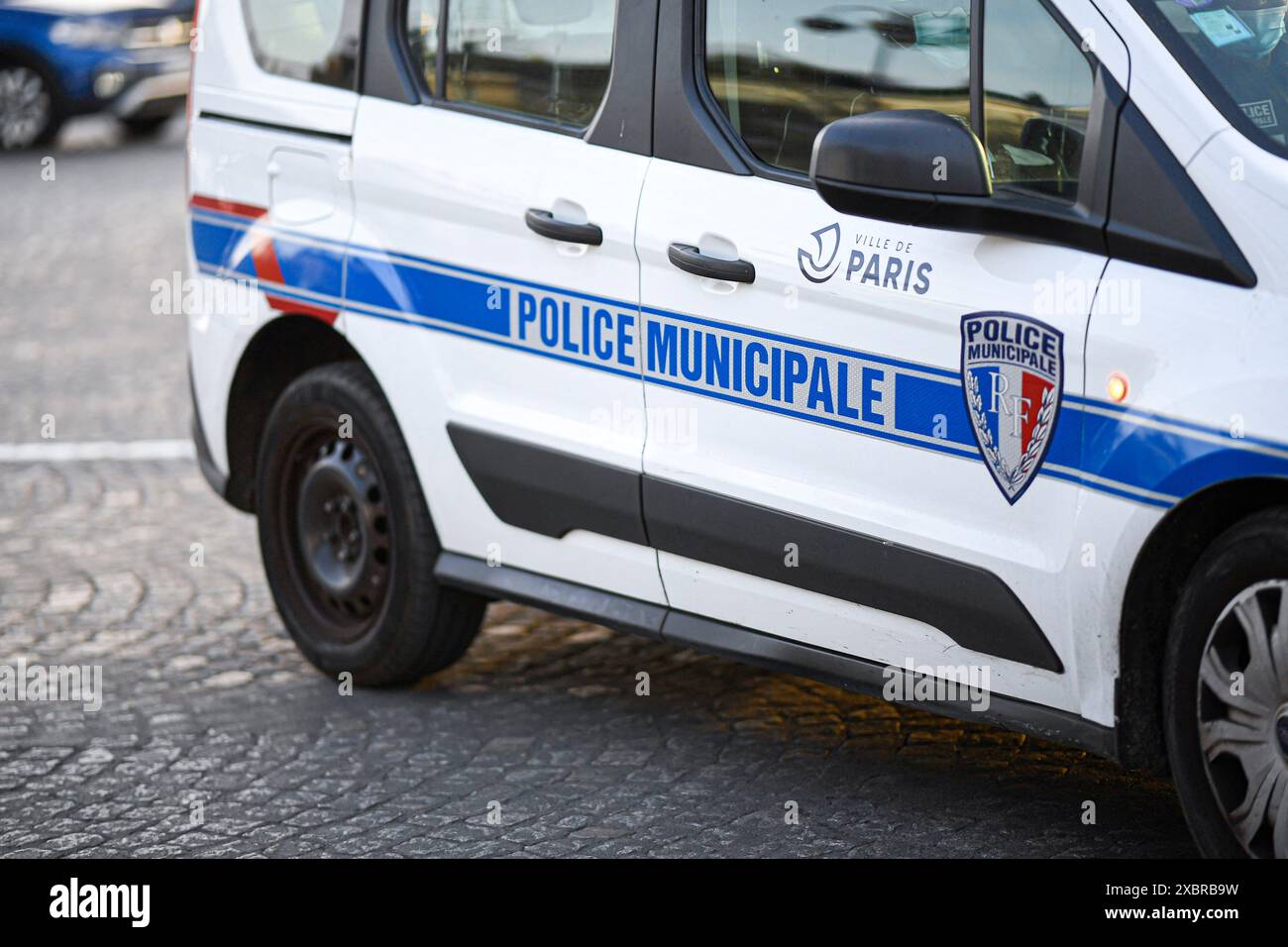 A municipal police car (truck, van) drives through the city ensuring ...