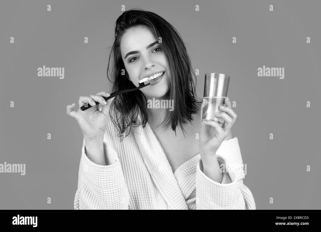 Smiling young woman with healthy teeth holding a tooth brush. Human ...