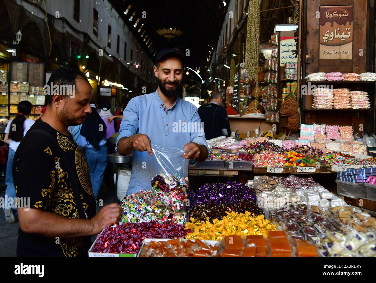 (240613) -- DAMASCUS, June 13, 2024 (Xinhua) -- People shop for sweets for the upcoming Eid al ...