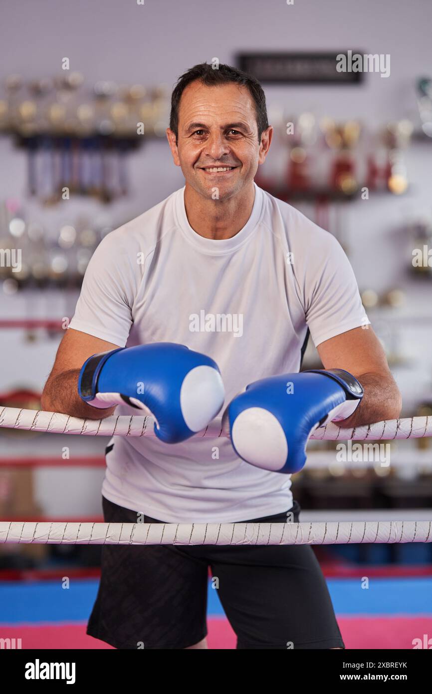 Kickboxing coach posing inside the ring, inviting you for a sparring ...