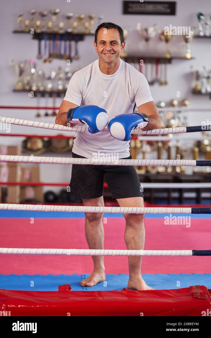 Kickboxing coach posing inside the ring, inviting you for a sparring ...