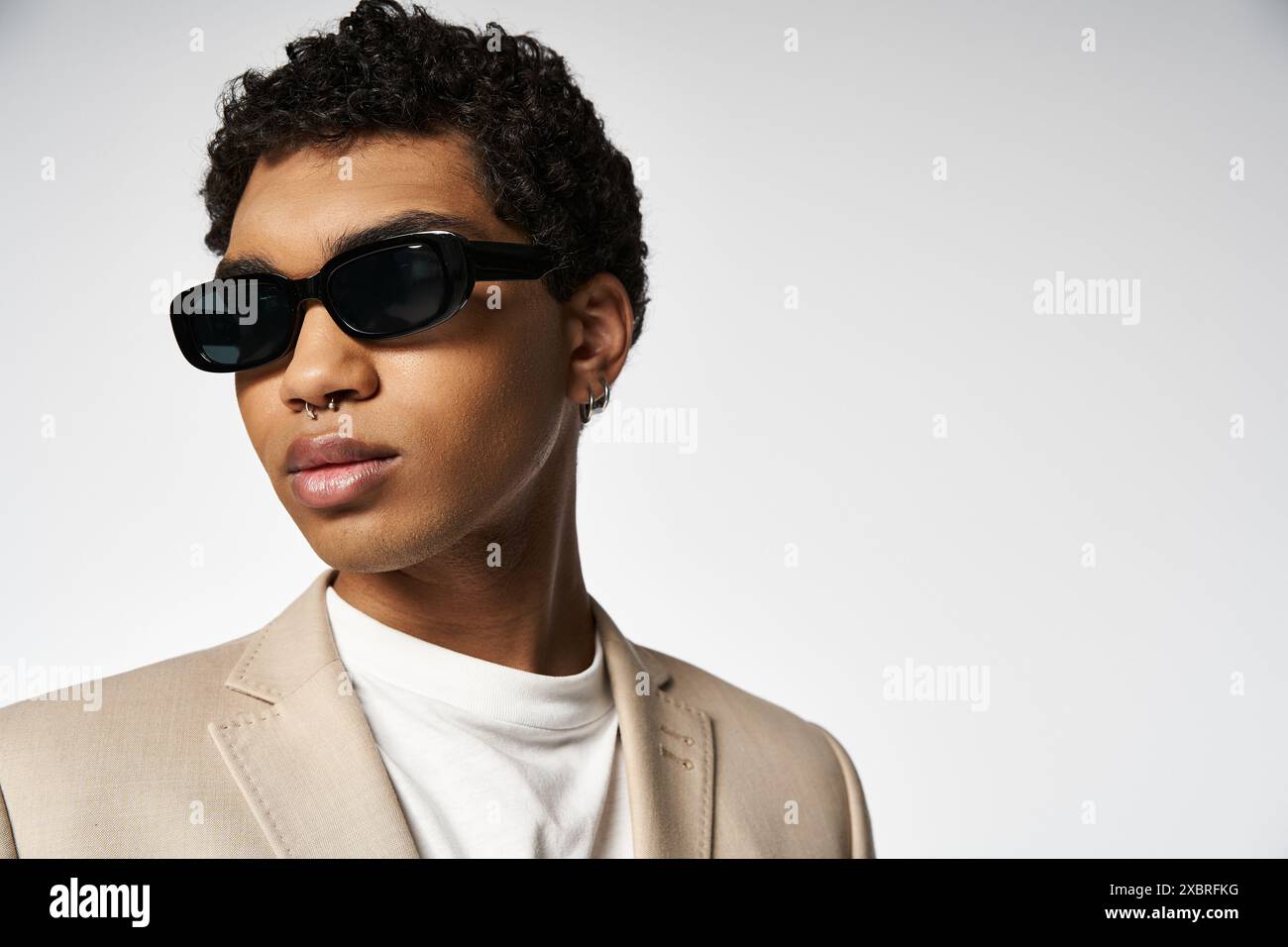 Stylish young man in tan suit and sunglasses Stock Photo - Alamy