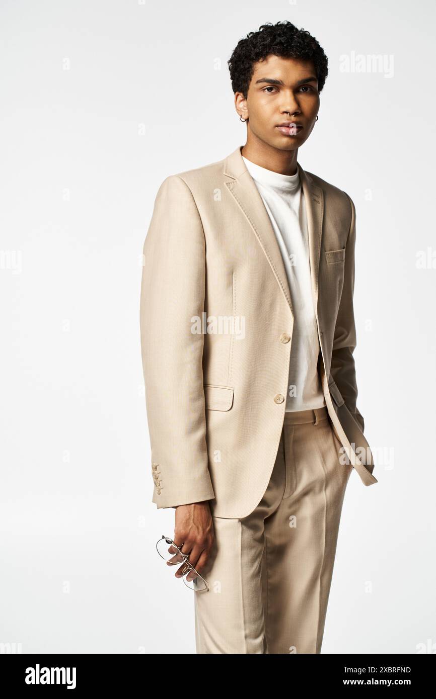 Stylish African American man in tan suit strikes a pose for the camera ...