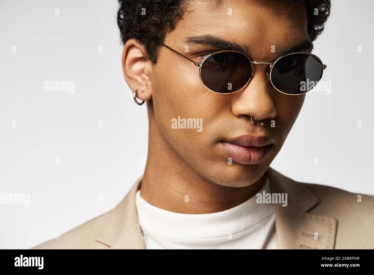 Stylish young man in tan suit and sunglasses Stock Photo - Alamy
