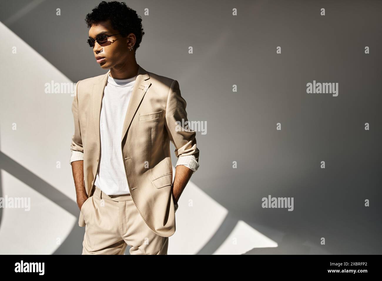 Handsome African American man in tan suit and sunglasses strikes a ...