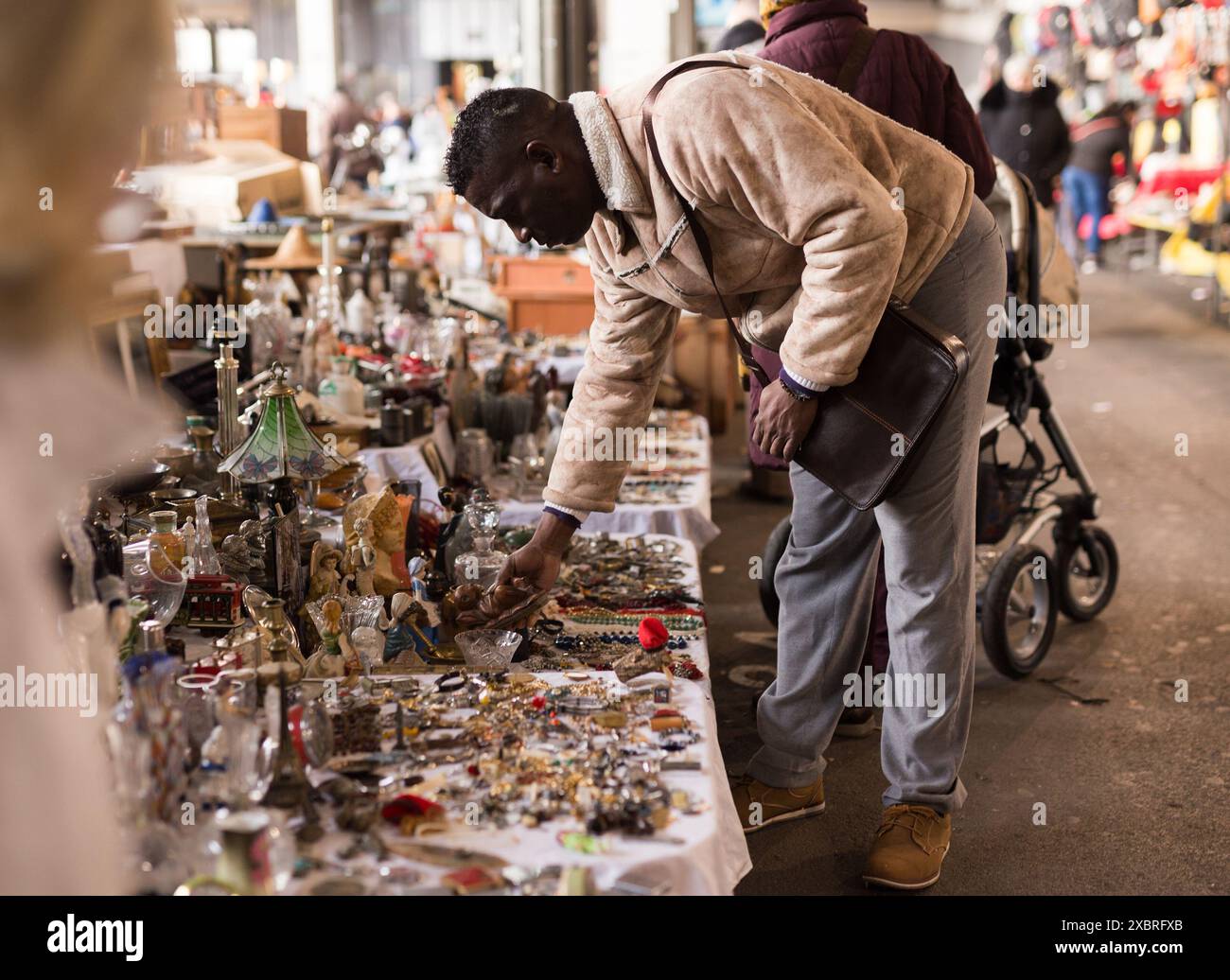 South African man selects antiques at a flea market Stock Photo - Alamy