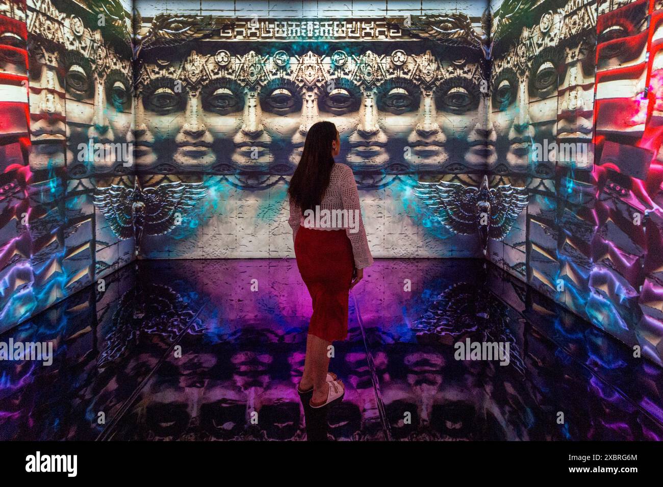 London, UK. 13 June 2024. A staff member in room 1 'Entheon: A Place to ...