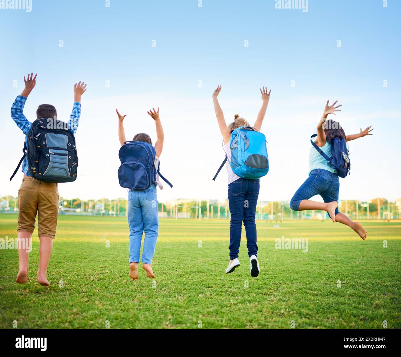 Excited kids, jump and group with back to school, outdoor and students ...