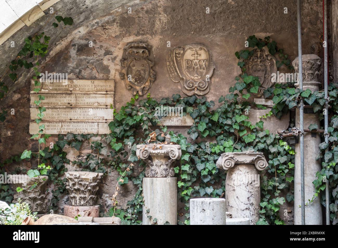 Roman columns and pieces of stone carving in the courtyard of Castello ...
