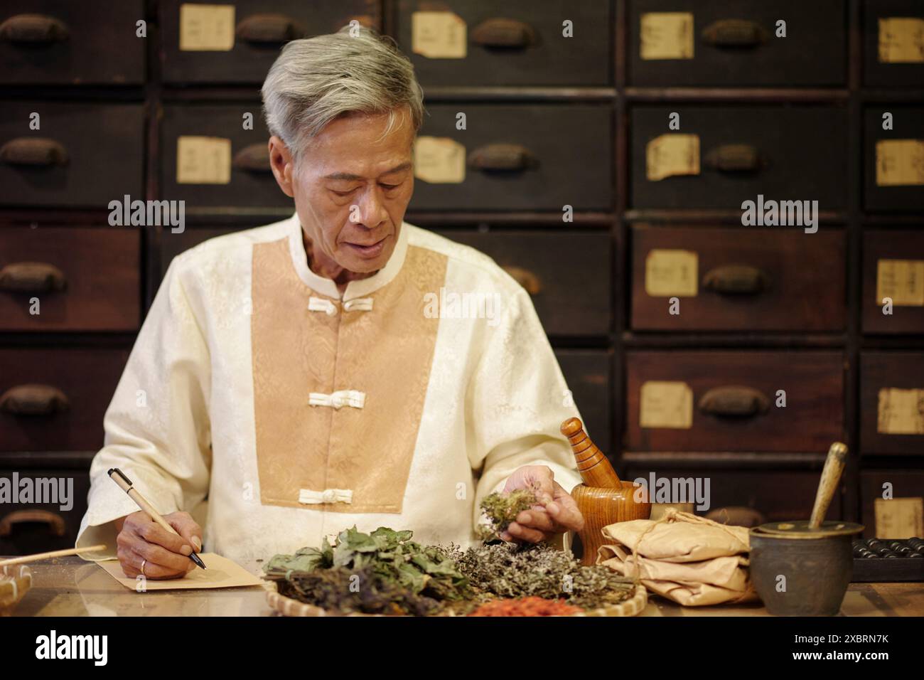 Man Making a List of Medicinal Herbs Stock Photo - Alamy
