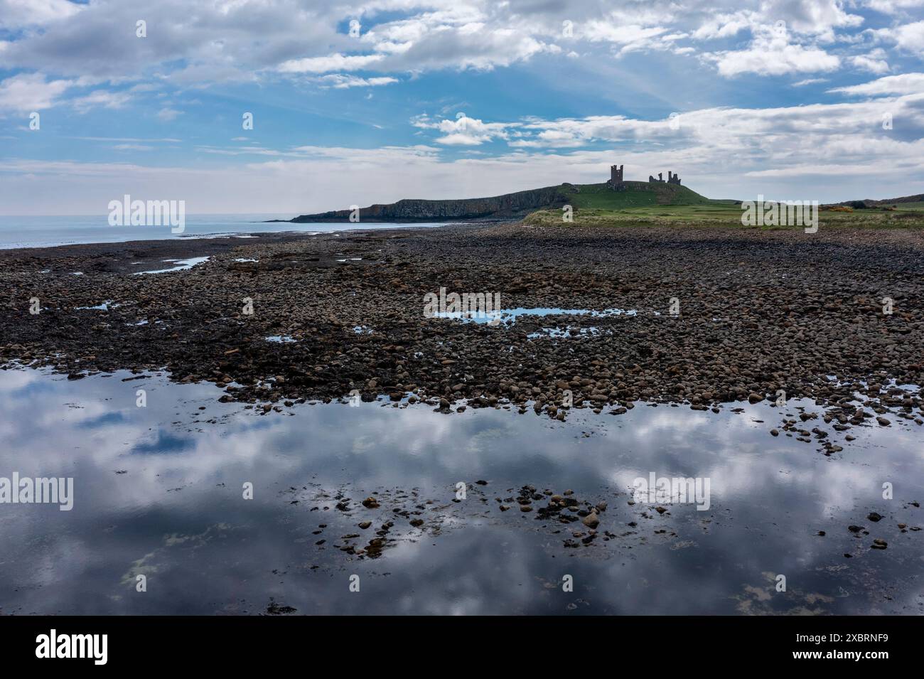 Dunstanburgh Castle from the north at low tide elevated view daytime ...