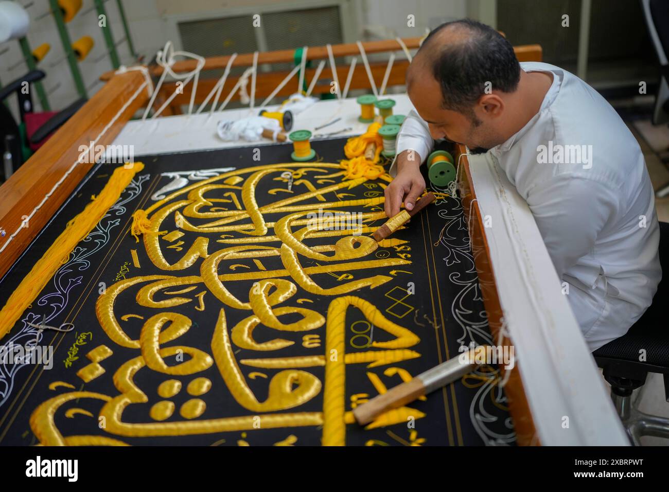 A Saudi man embroiders Islamic calligraphy, using either pure silver ...