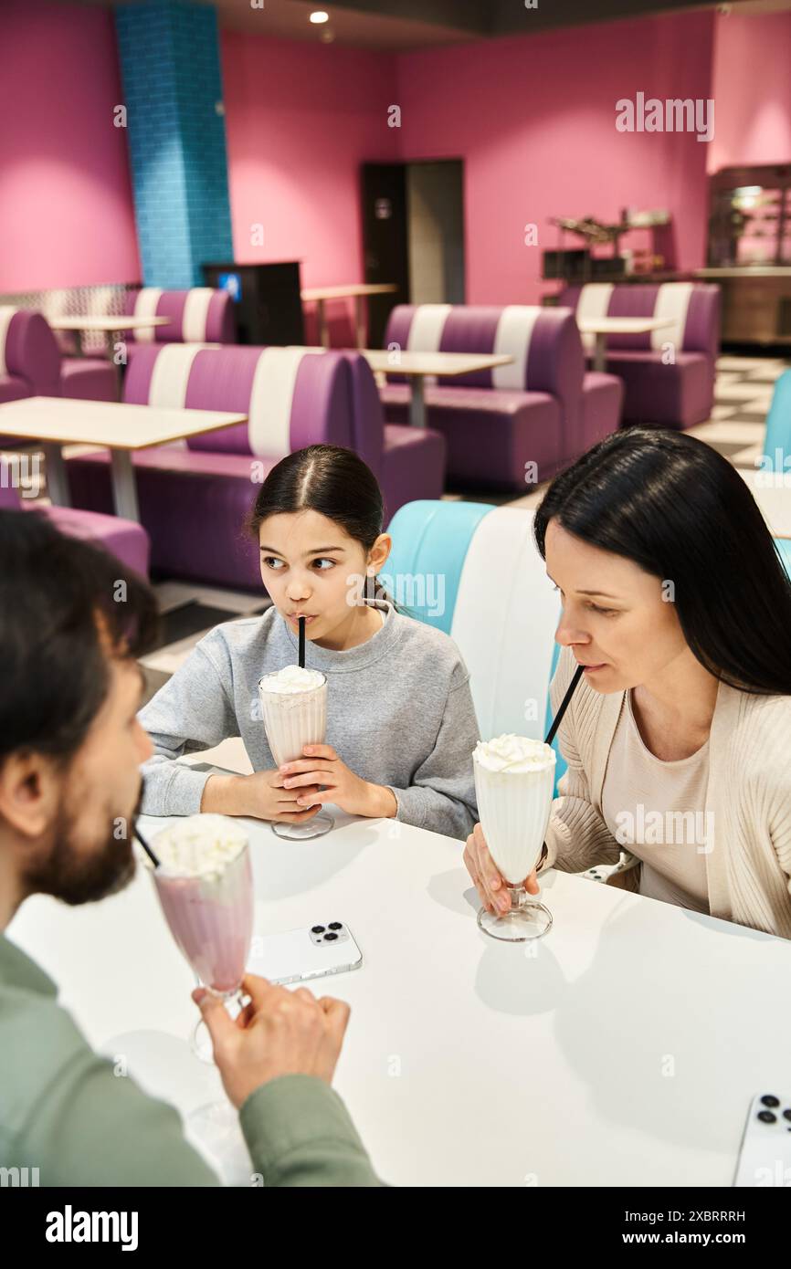 A family enthusiastically enjoying delicious milkshakes at a modern ...