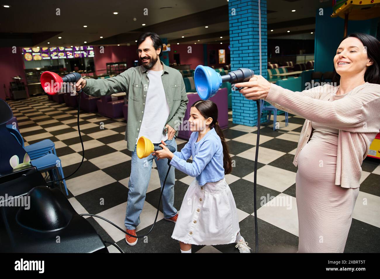 A happy family, parents and kids, immersed in lively game competition ...
