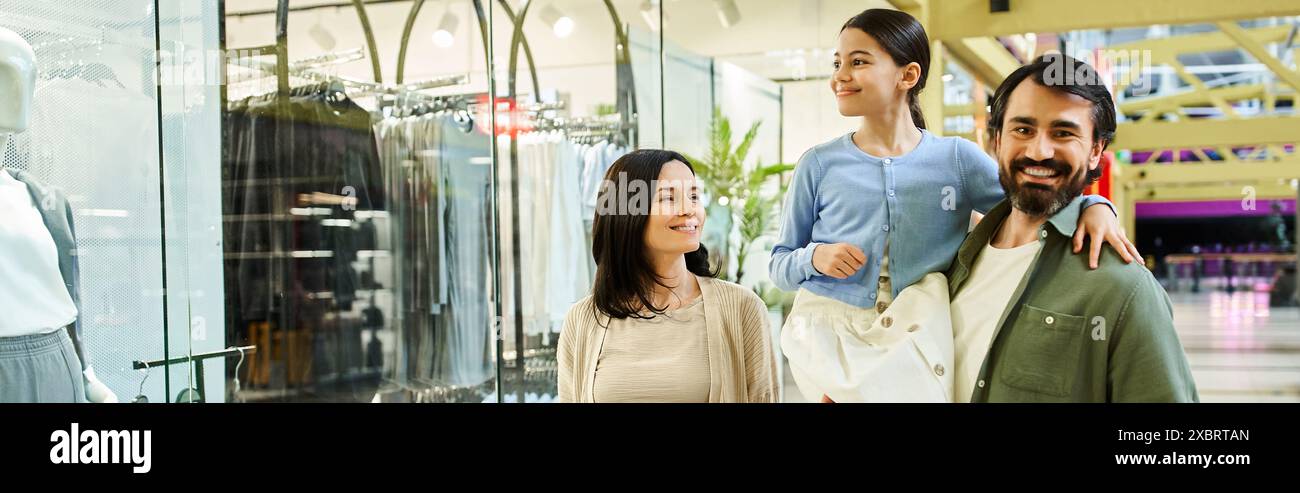 A cheerful family explores shops together in a bustling shopping mall ...