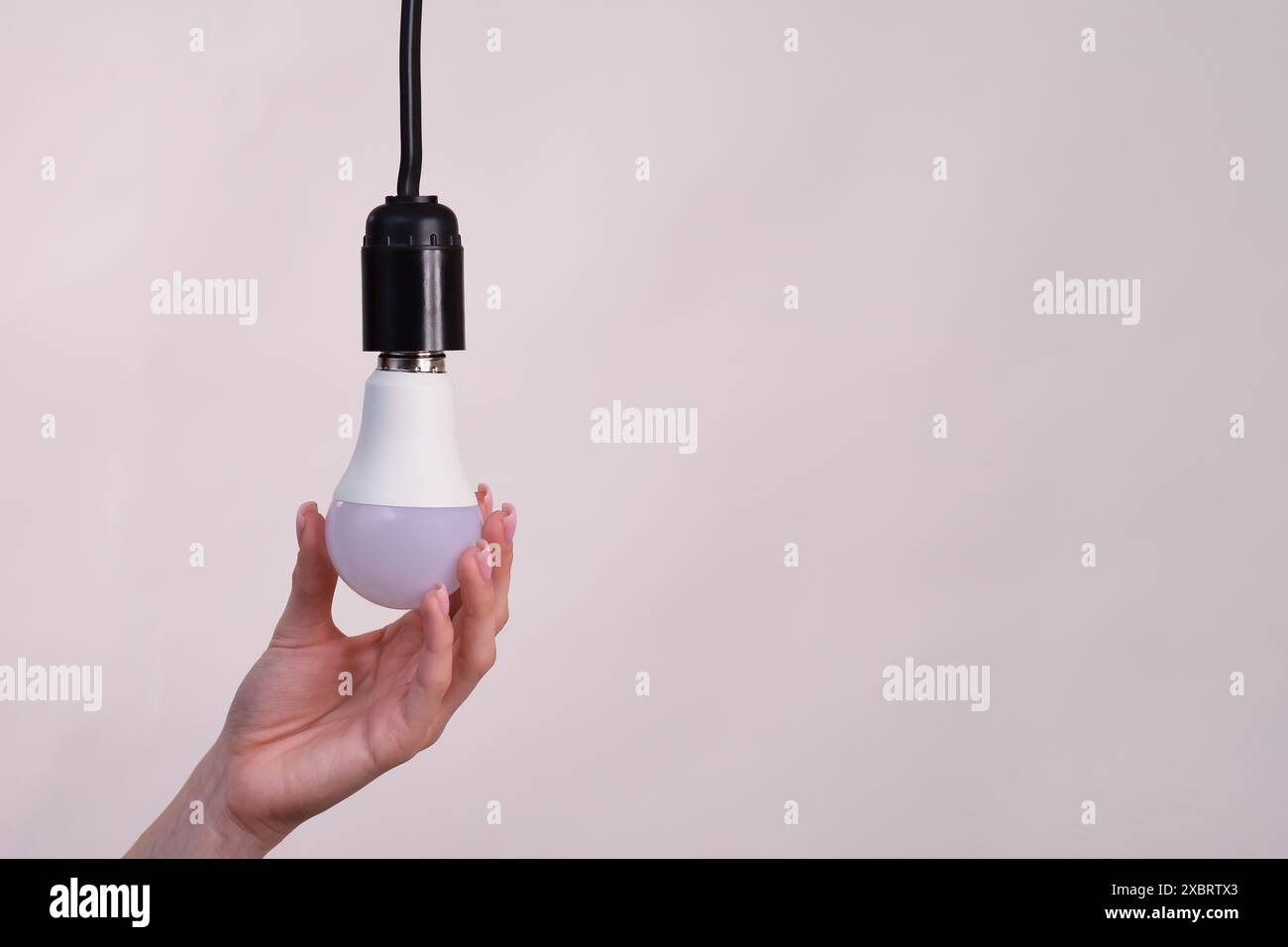Electric LED light bulb. Changes on a white background Stock Photo - Alamy