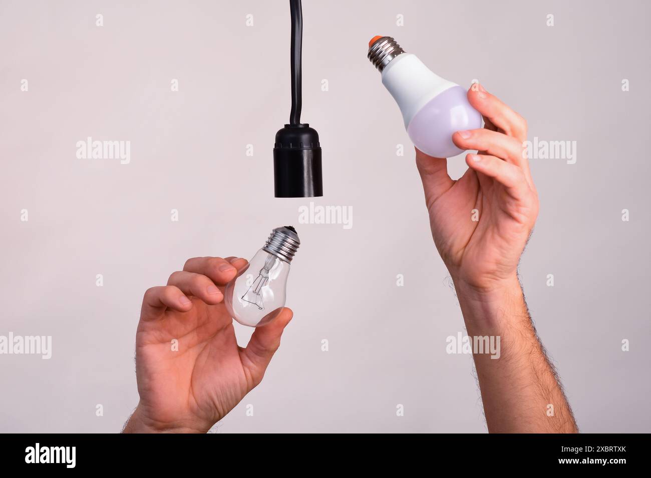 the concept of replacing an incandescent light bulb with an LED lamp ...