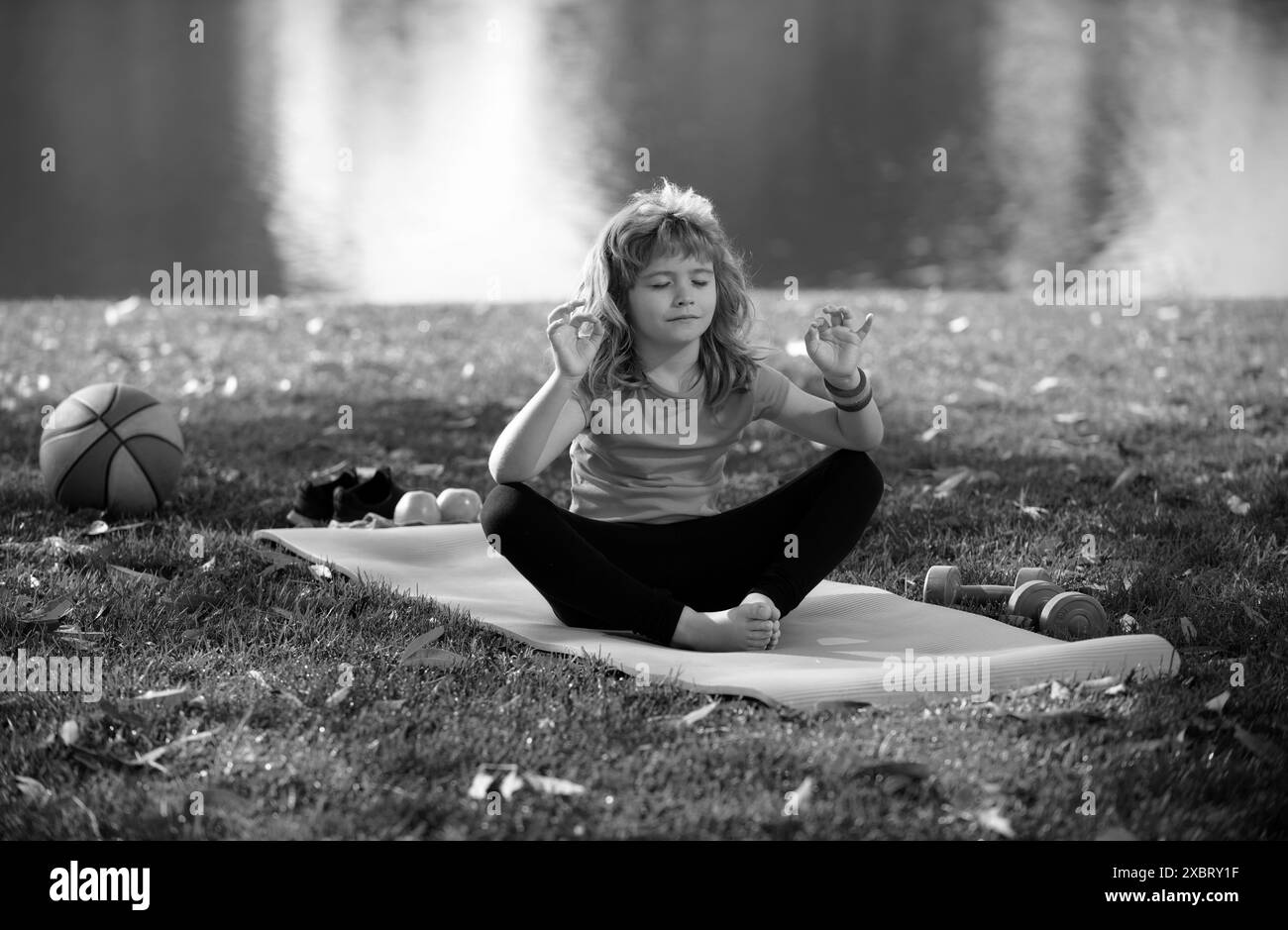 Cute little boy, kid meditating in park. Portrait of child doing yoga ...