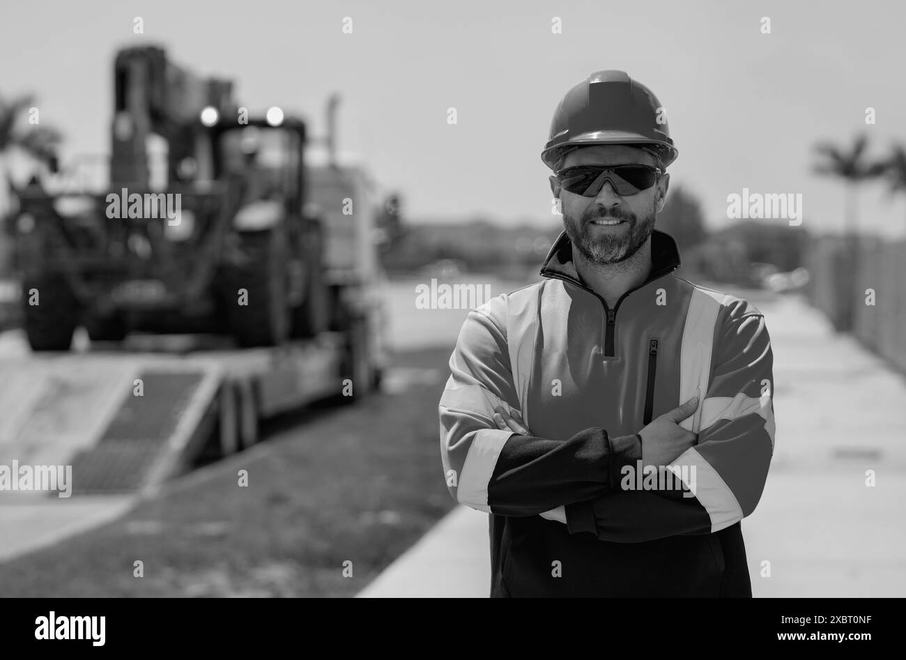 Builder in helmet with excavator for construction at the construction ...
