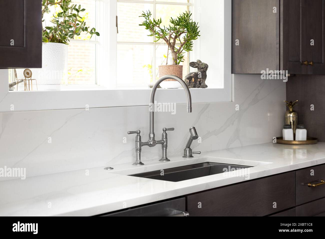 A kitchen faucet detail in a cozy kitchen with a stainless faucet ...