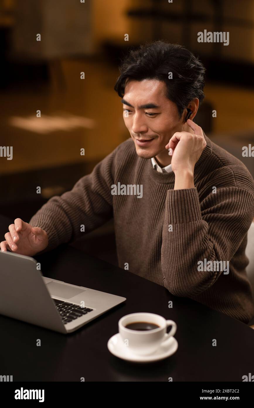 Man using cordless earbuds hi-res stock photography and images - Alamy