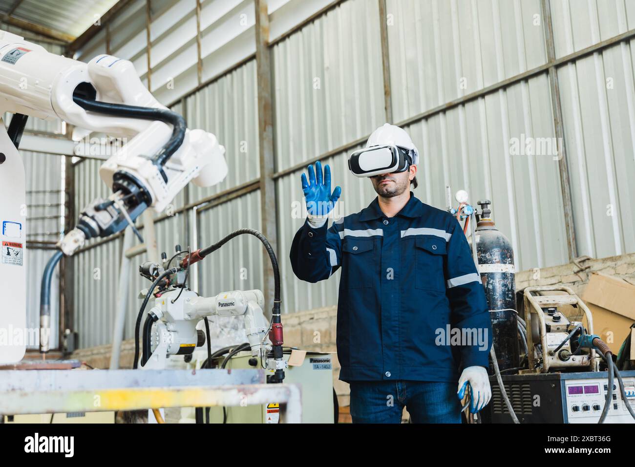 engineer using vr Glasses for controlling the robotic welding arm in ...