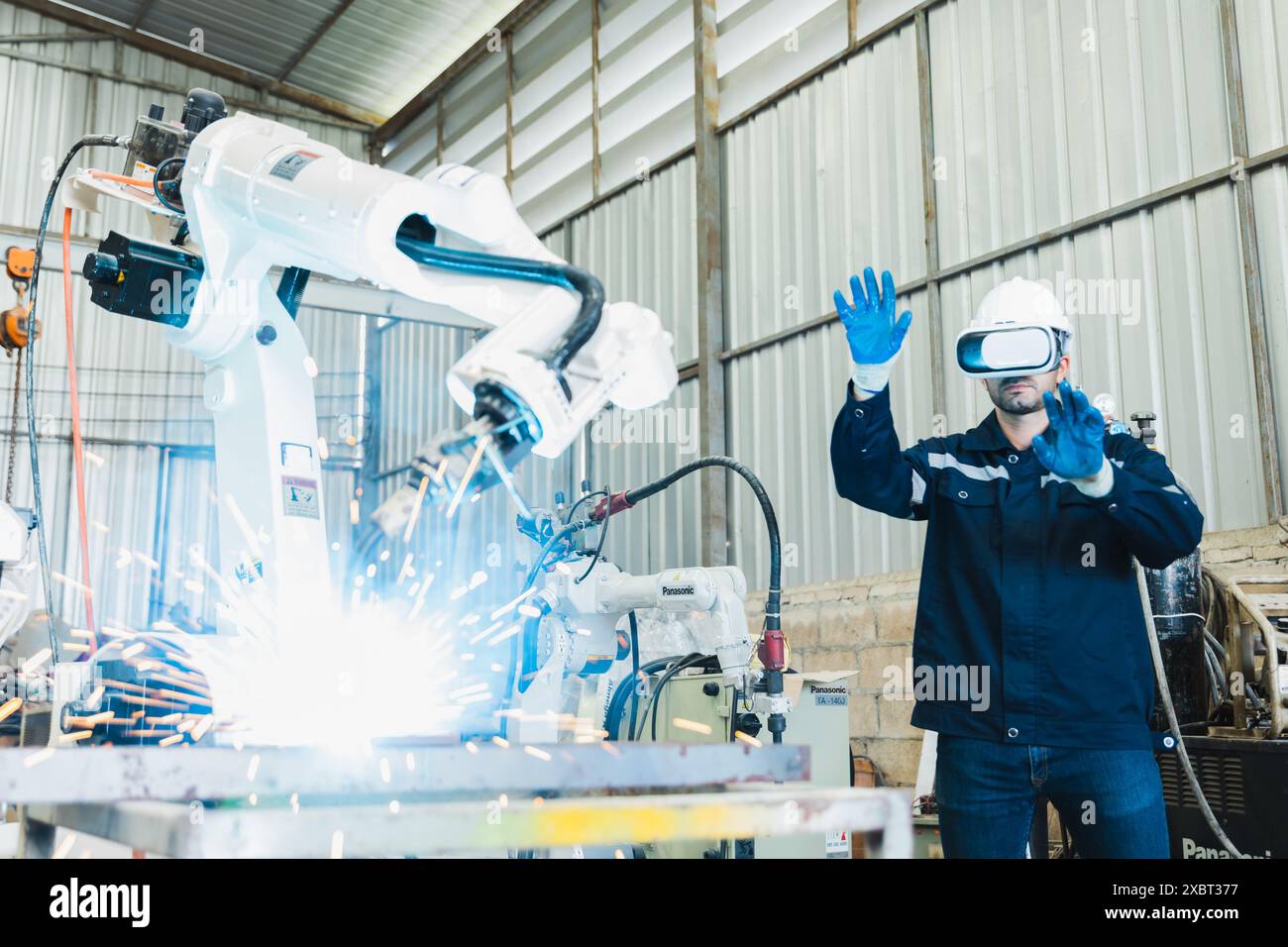 engineer using vr Glasses for controlling the robotic welding arm in ...