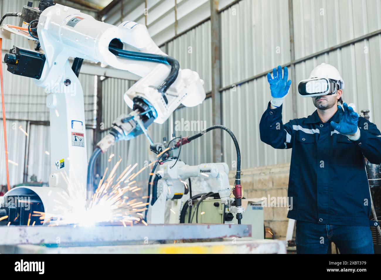 engineer using vr Glasses for controlling the robotic welding arm in ...