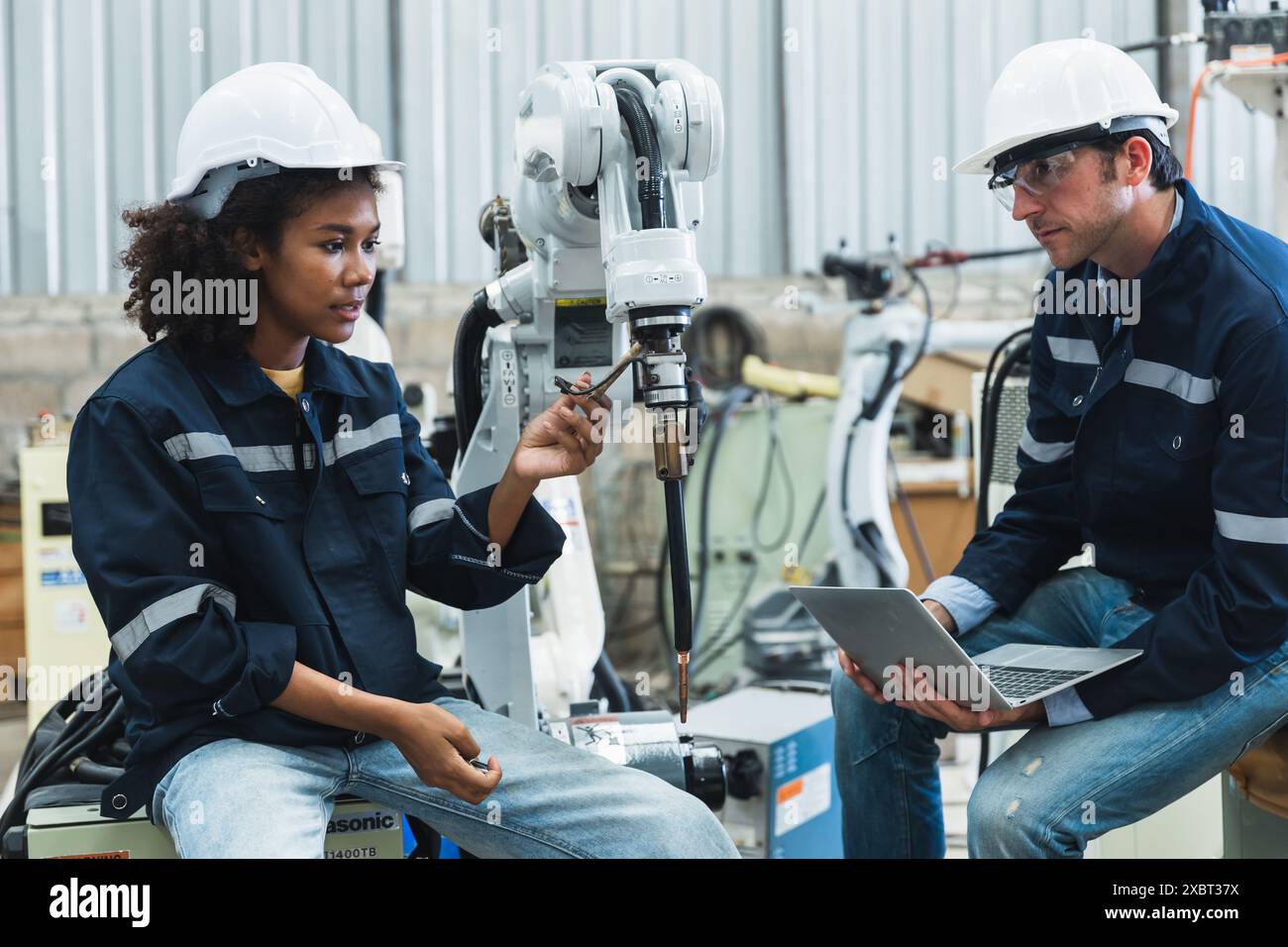 Engineer Controlling Robot Arm At Factory Checking The Operation Of Robot Arm Technology