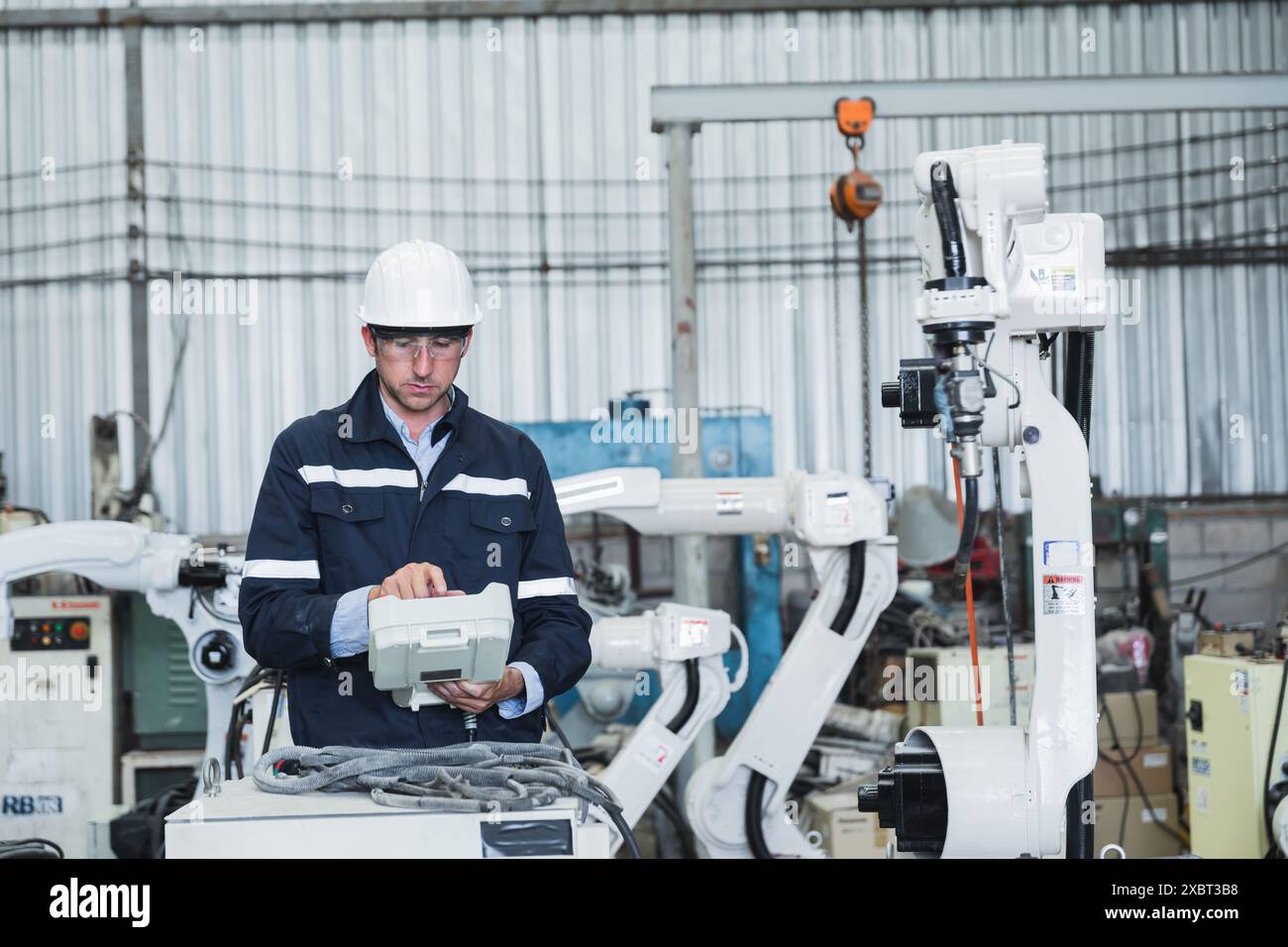 Engineer Controlling Robot Arm At Factory Checking The Operation Of Robot Arm Technology