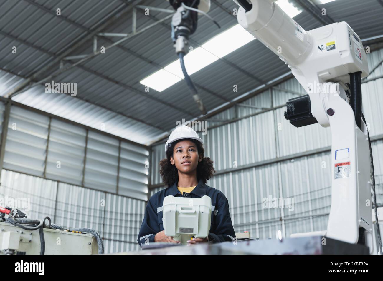 Engineer Controlling Robot Arm At Factory Checking The Operation Of Robot Arm Technology