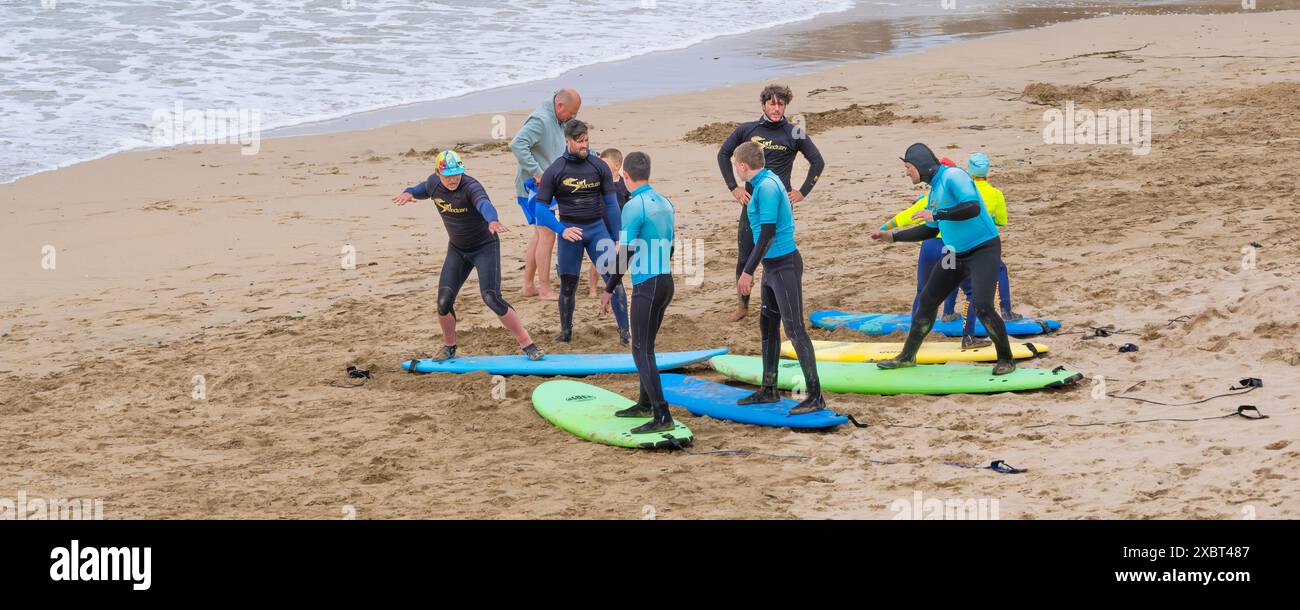 Surfing instructors guides teachers from Surf Sanctuary teaching a ...
