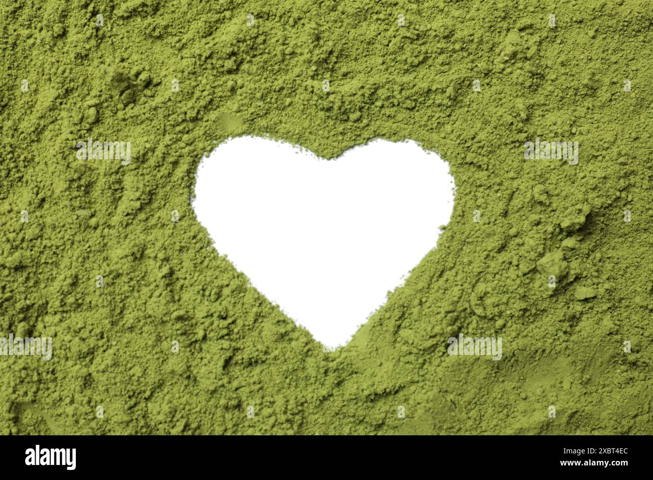 Heart-shaped frame made of green matcha powder on white background, top ...