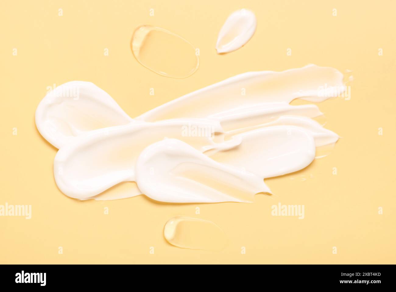 Samples of face cream on pale yellow background, top view Stock Photo ...