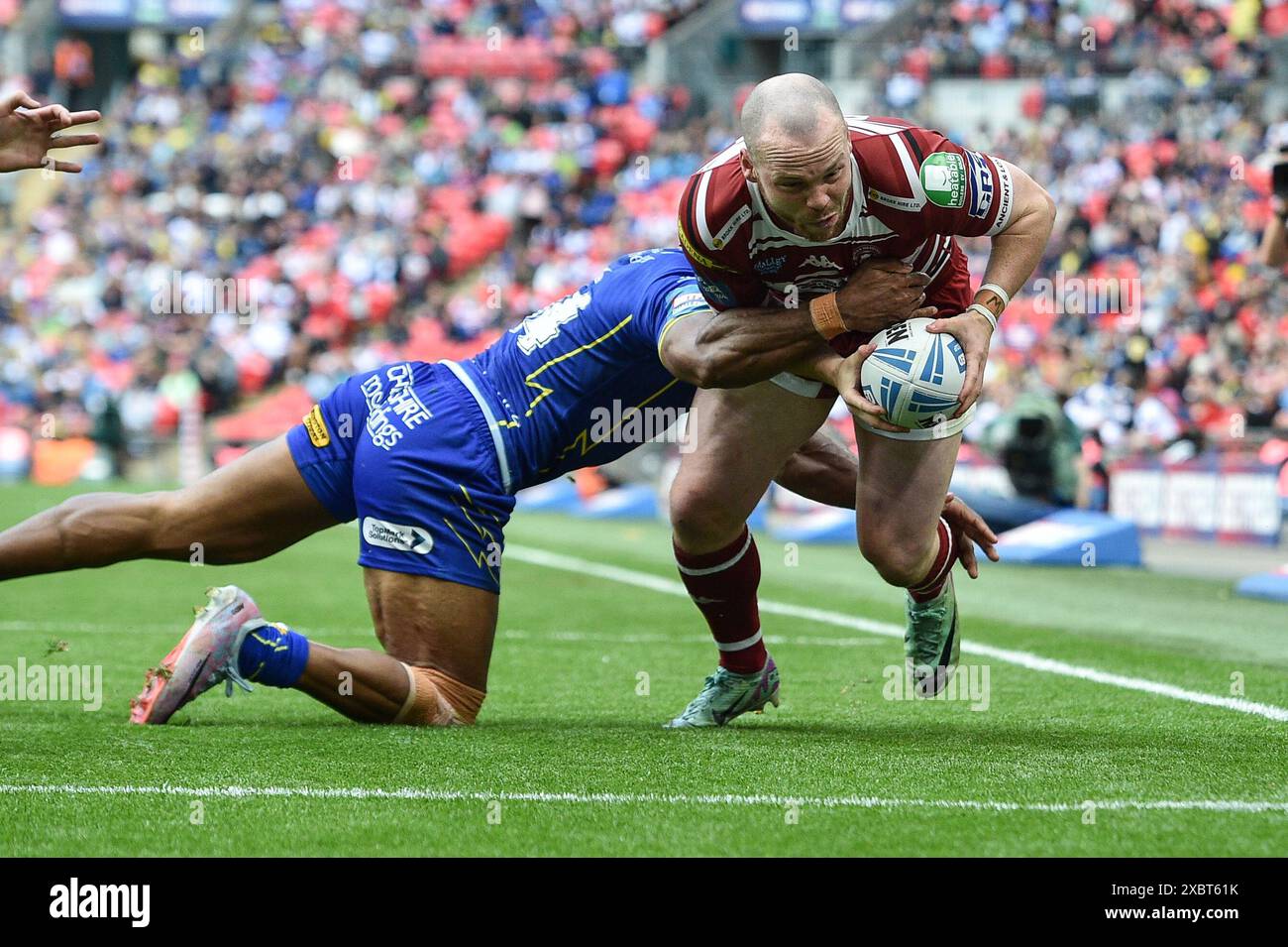London, England - 8th June 2024 - Liam Marshall of Wigan Warriors held ...