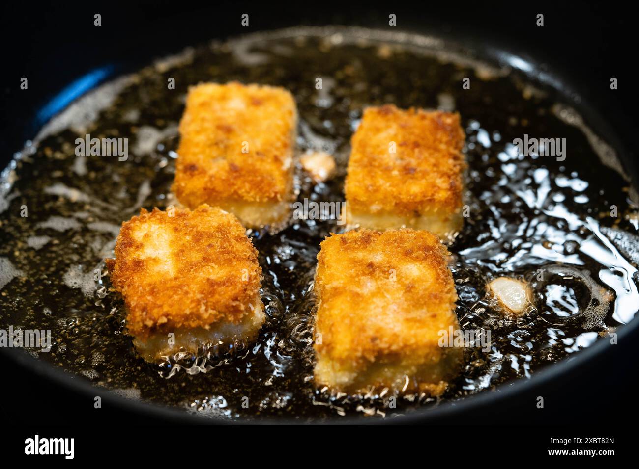 breaded and baked greek sheep's cheese with herbs and spices Stock ...