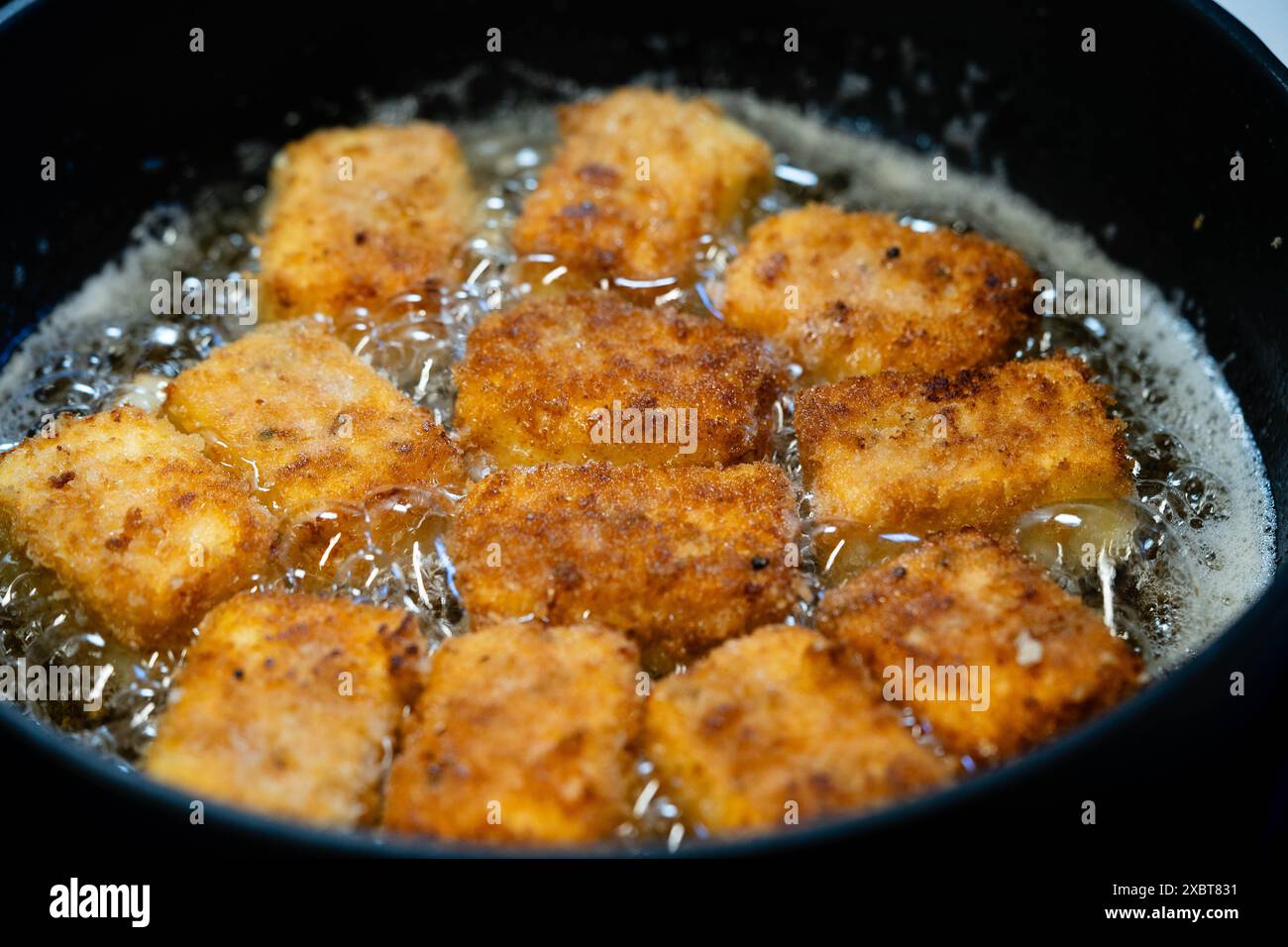 breaded and baked greek sheep's cheese with herbs and spices Stock ...