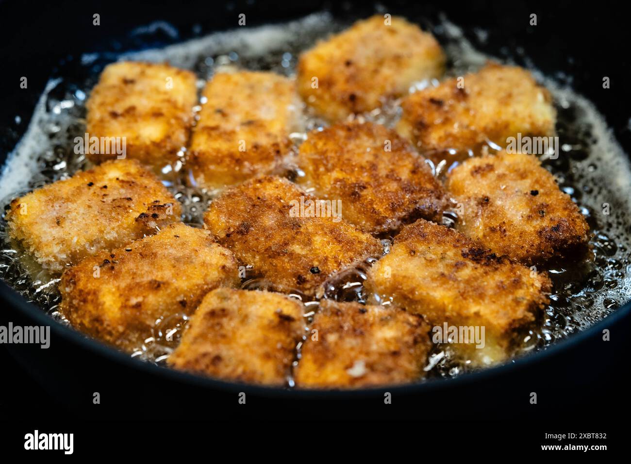 breaded and baked greek sheep's cheese with herbs and spices Stock ...