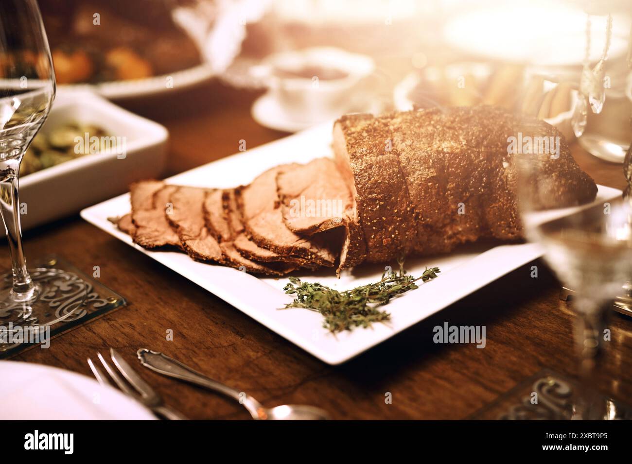 Holiday dinner, food or table with roast beef for Christmas meal, cut ...