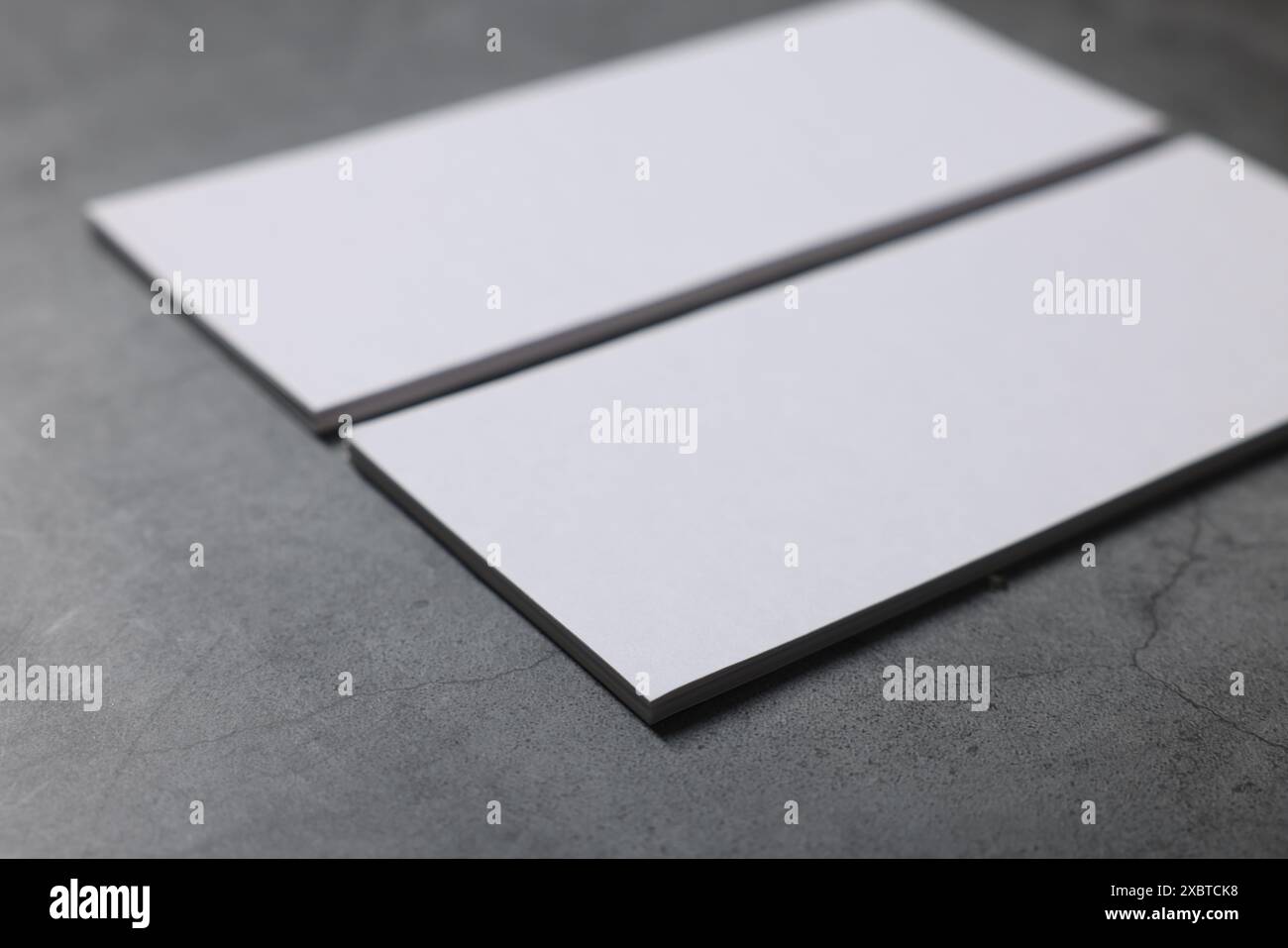 Blank business cards on grey textured table, closeup. Mockup for design ...