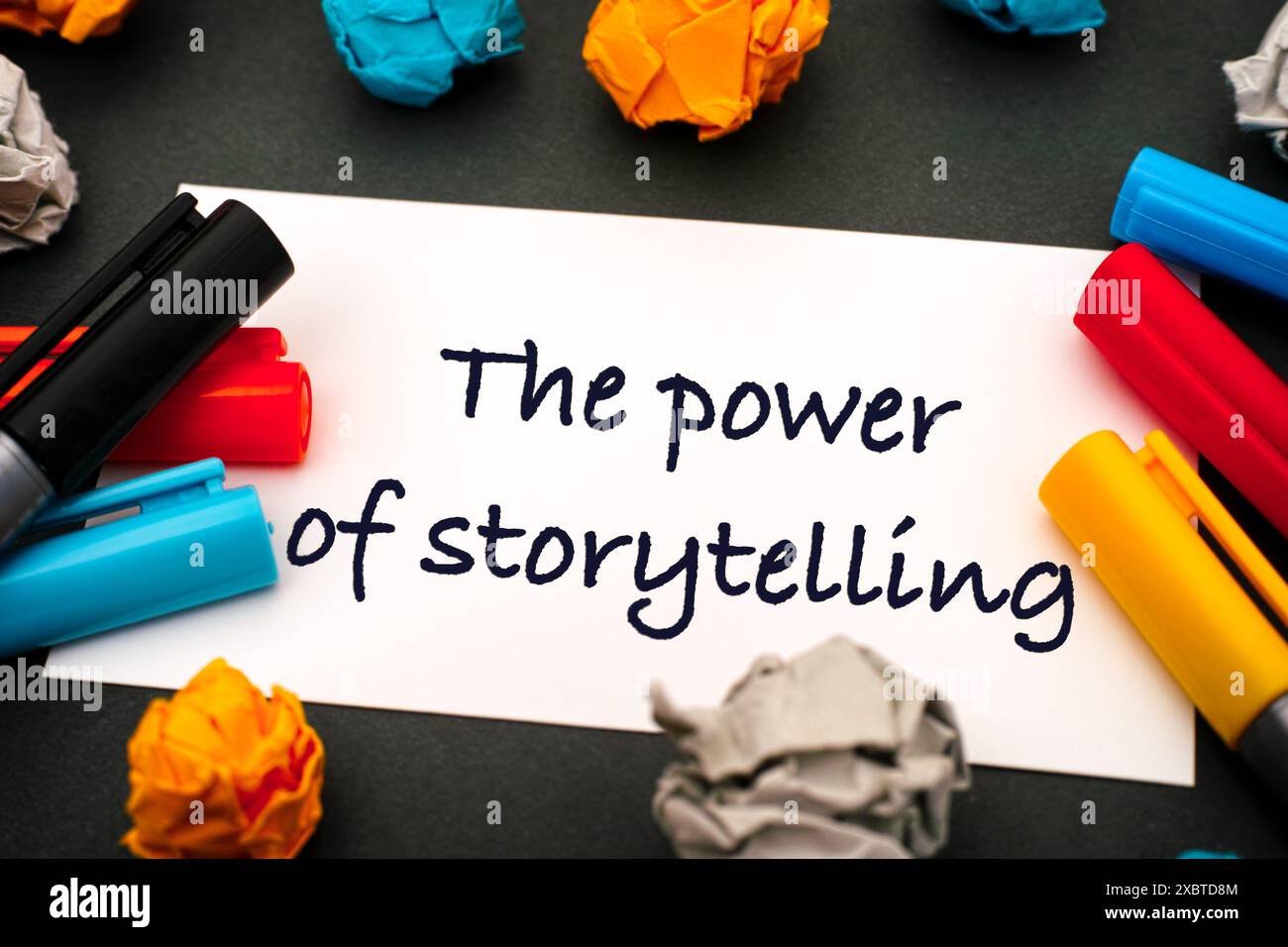 Paper with words The Power of Storytelling, colour pens and crumpled ...