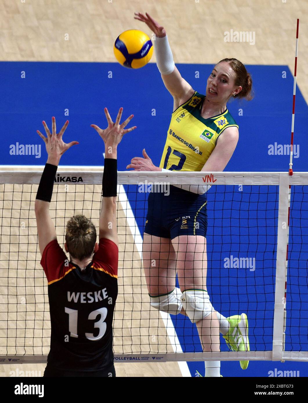 Hong Kong, China. 13th June, 2024. Julia Bergmann (R) of Brazil spikes ...